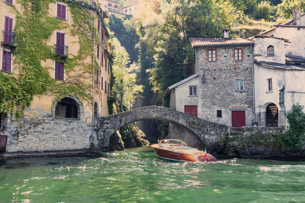 Nesso Bridge Wooden Boat, Lake Como – Gray Malin